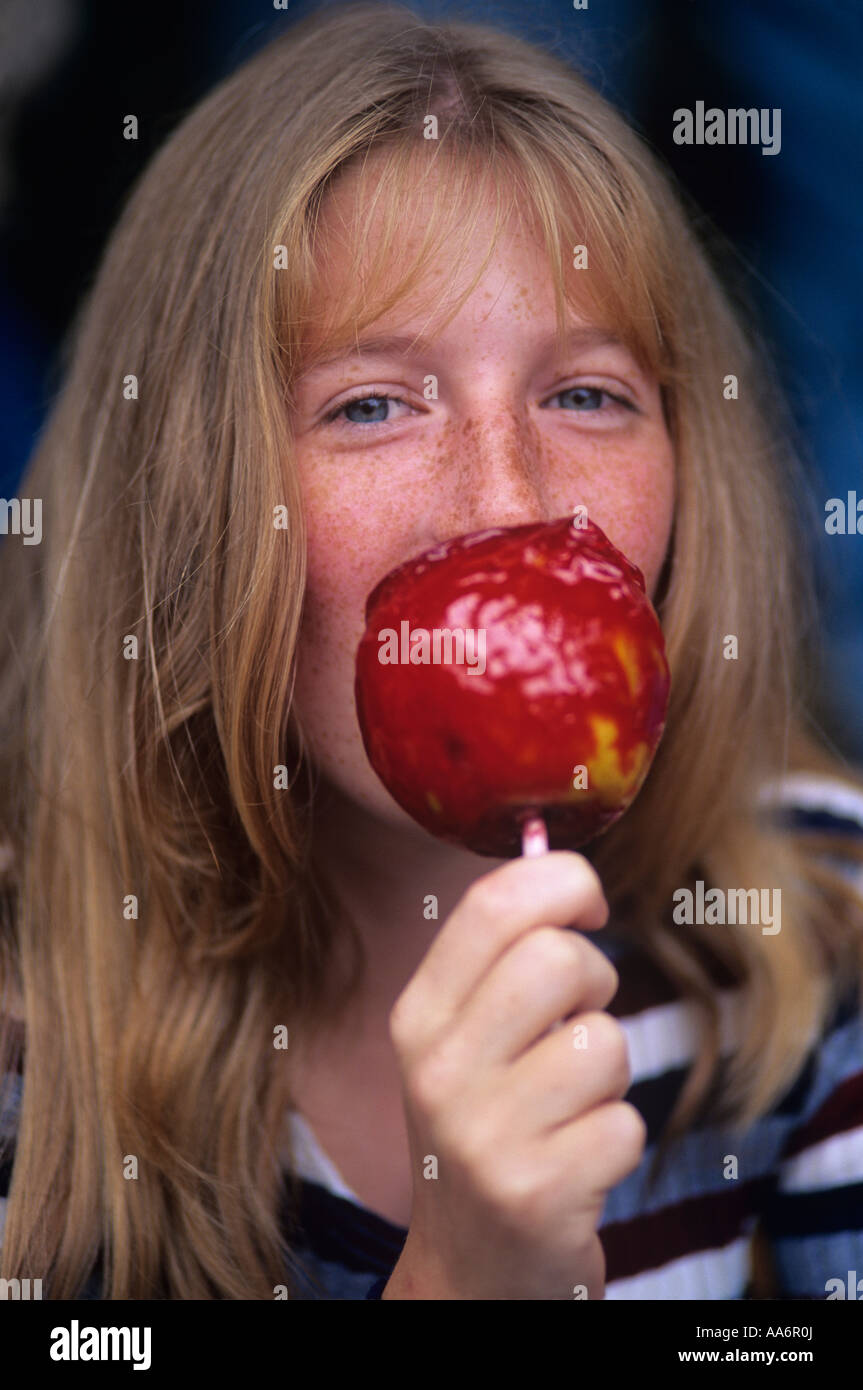 USA Maryland Oakland Sarah Slattery eats candy apple along the parade ...