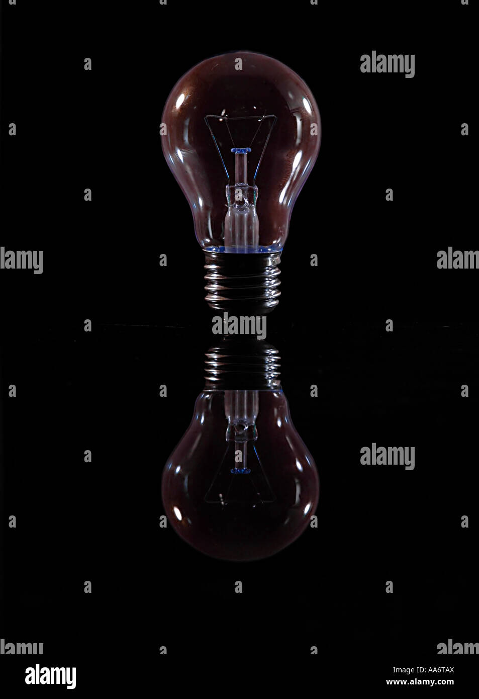A light bulb on black background with a reflection Stock Photo - Alamy