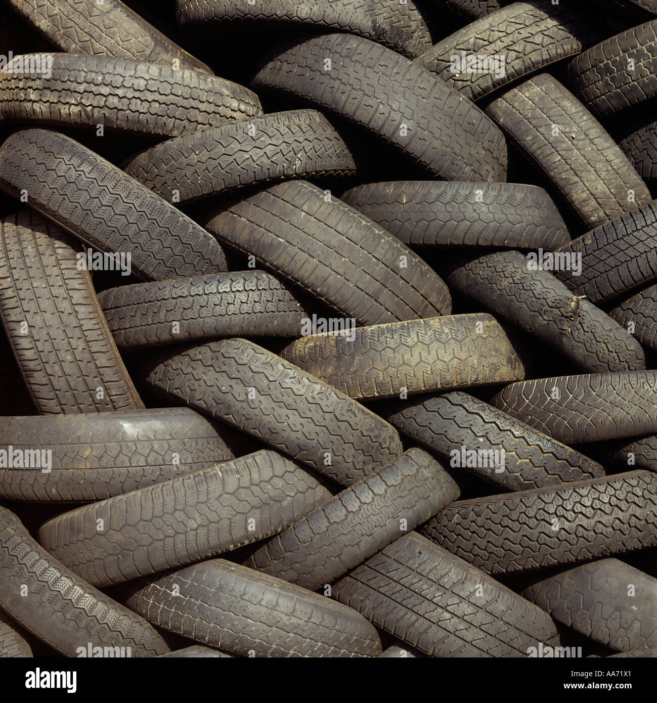 Rubber motor vehicle tyres stacked at a waste transfer station before ...