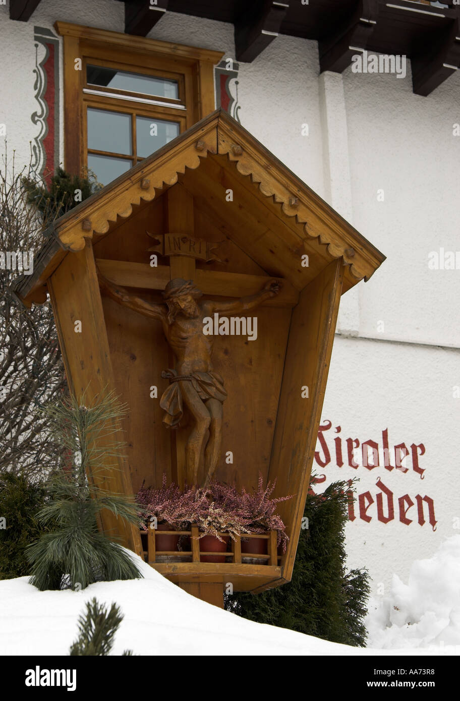 A wooden crucifix outside a house, ski resort of St. Anton am Arlberg ...