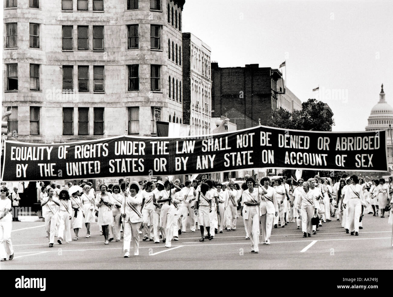 Women carry a large banner down Pennsylvania Avenue demand equality of ...