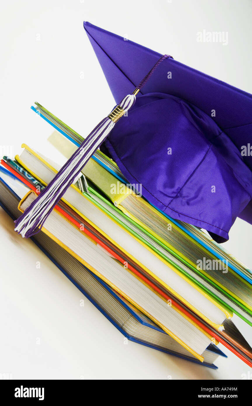 Graduation cap on books Stock Photo - Alamy