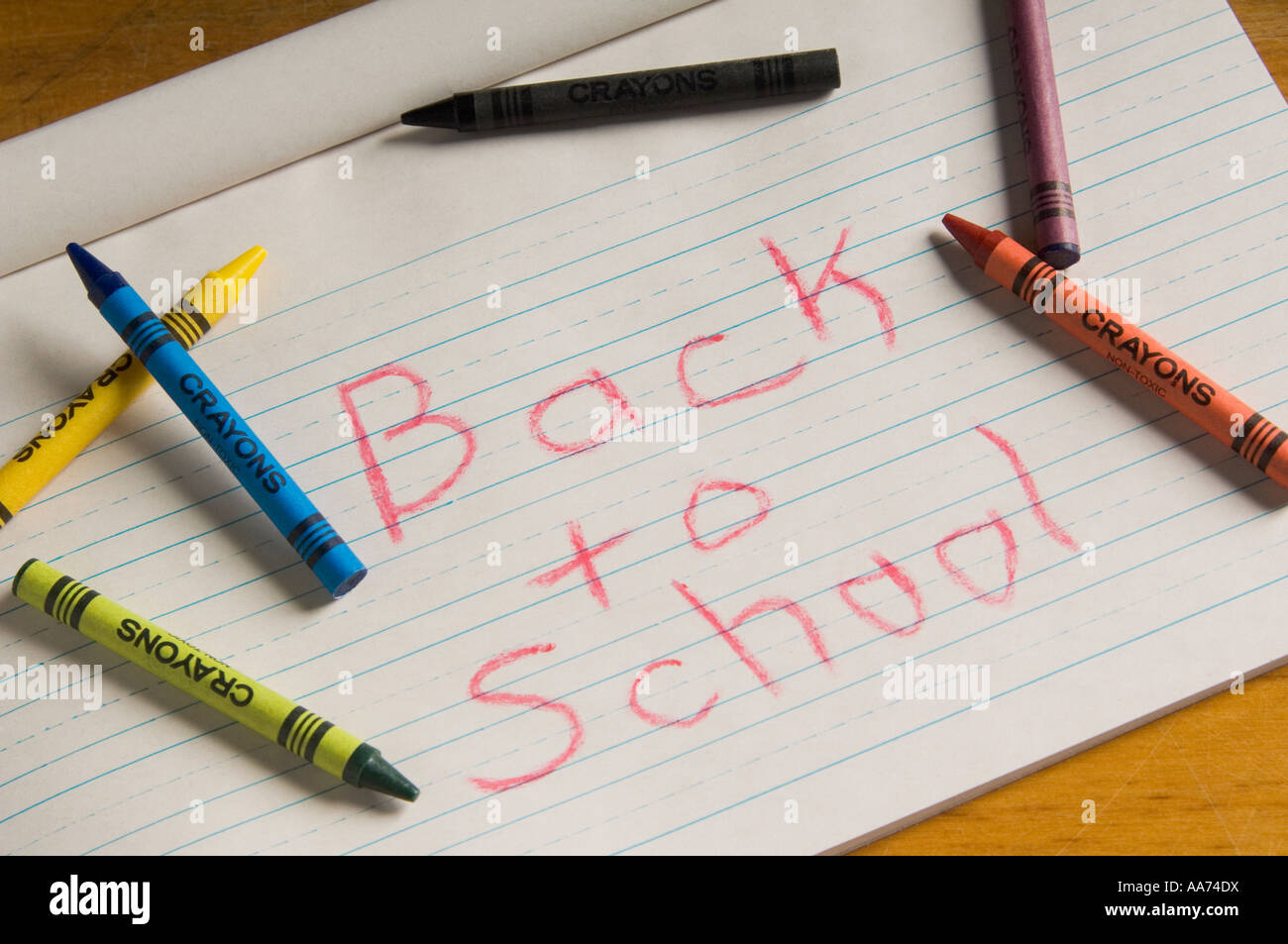 Writing pad and crayons Stock Photo - Alamy