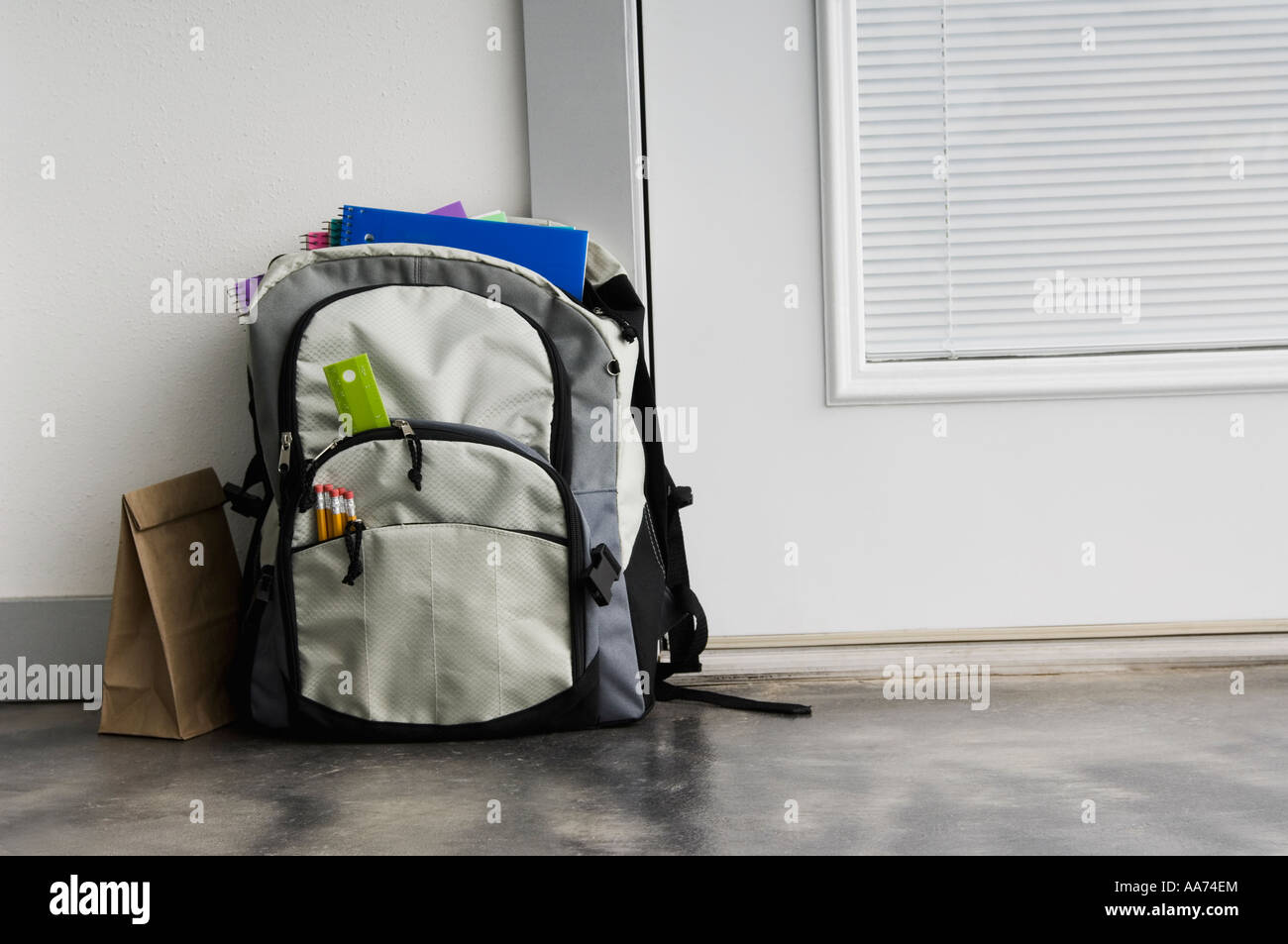 School backpack by door Stock Photo - Alamy