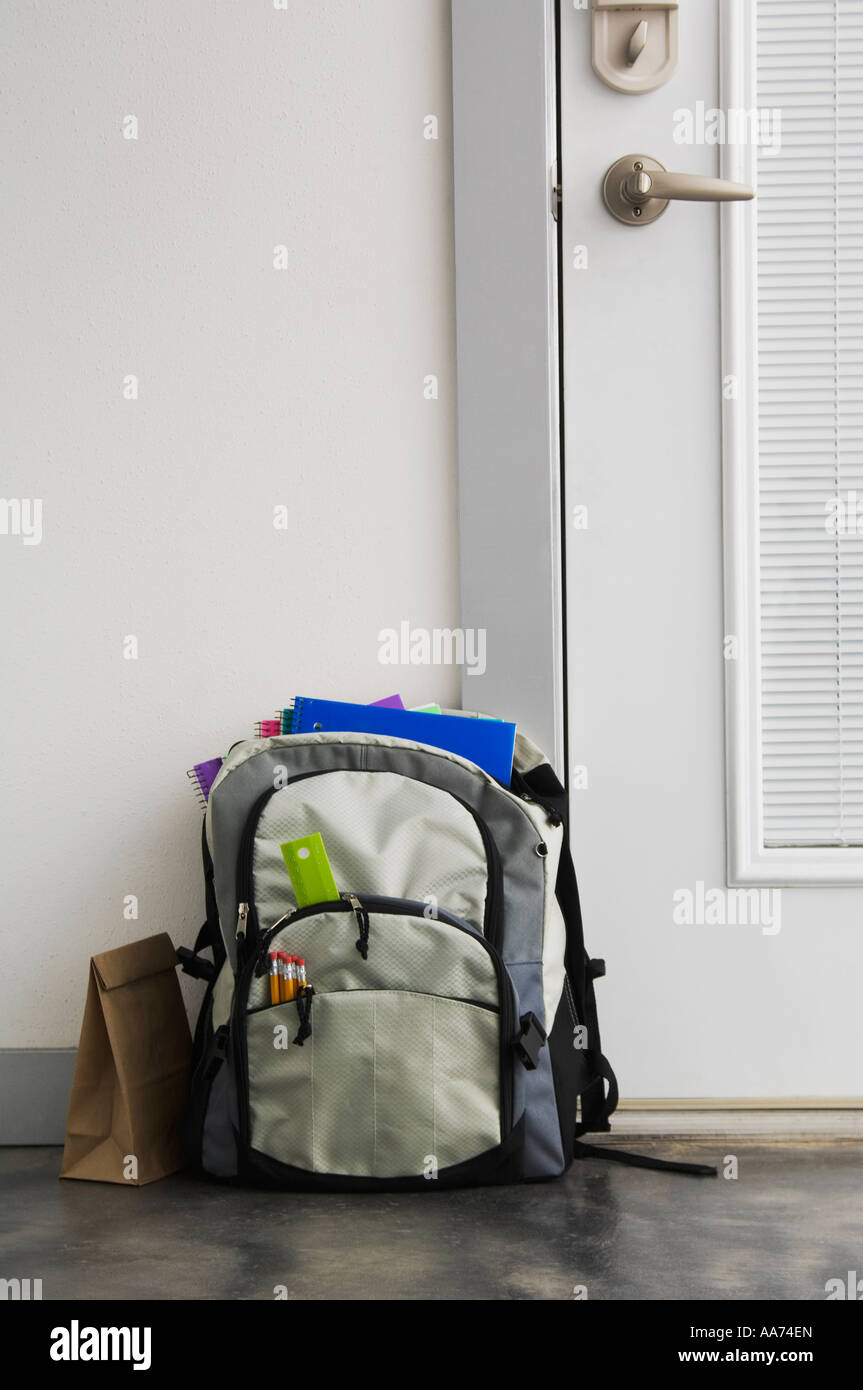 School backpack by door Stock Photo - Alamy