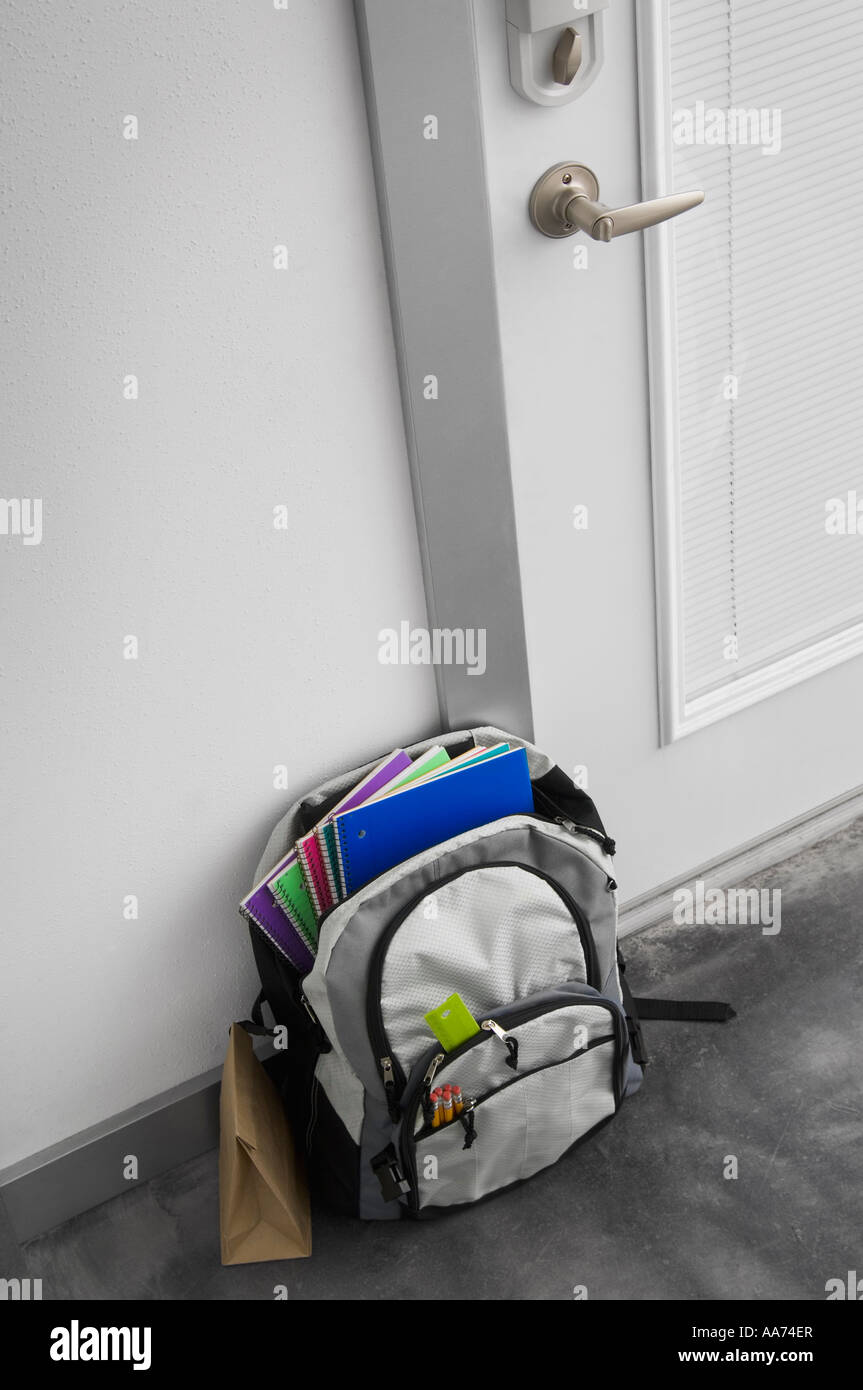 School backpack by door Stock Photo - Alamy