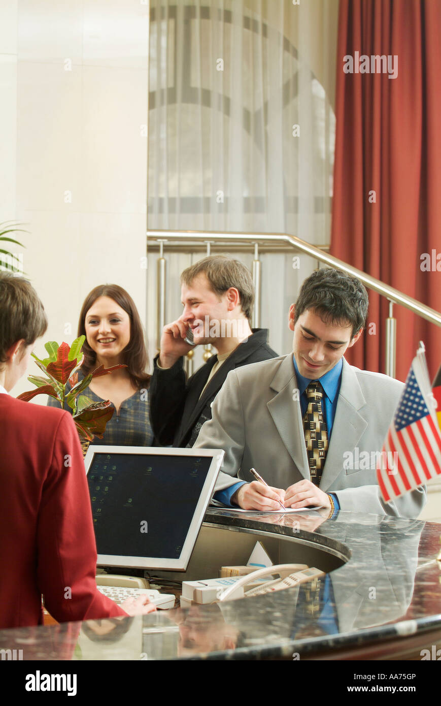 Man checking into hotel Stock Photo - Alamy