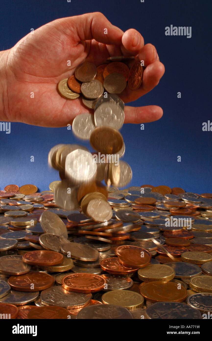 Pouring out money from a hand Stock Photo - Alamy