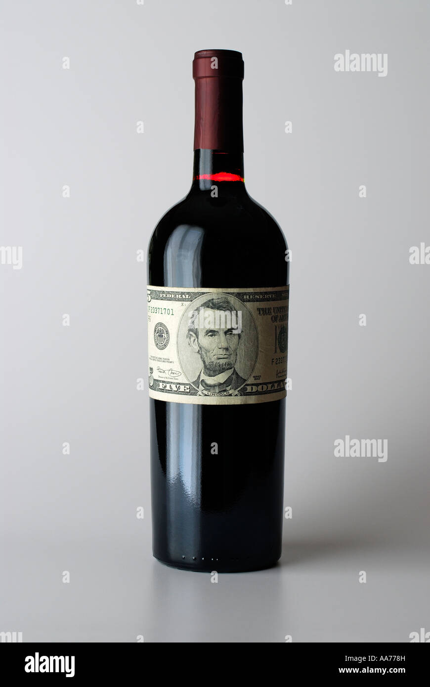 "Bottle of red wine with five ^US "dollar bill" instead of label Stock ...