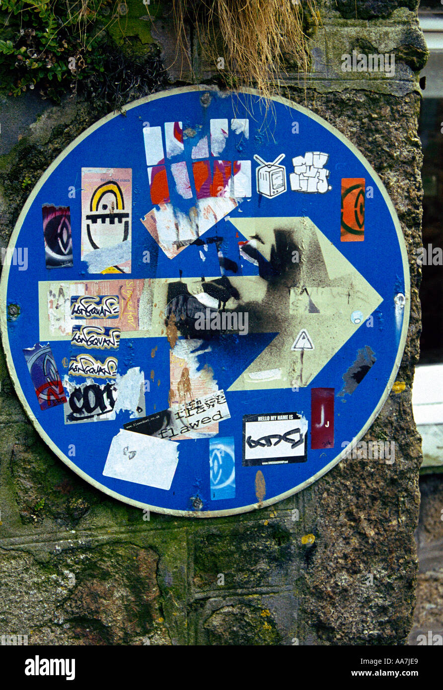 A close up of a one way roadsign covered in graffiti at St Ives ...