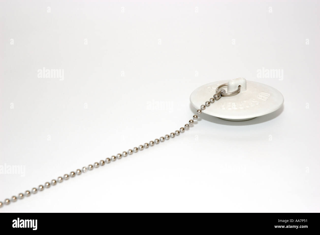 Sink plug with chain over white background Stock Photo - Alamy