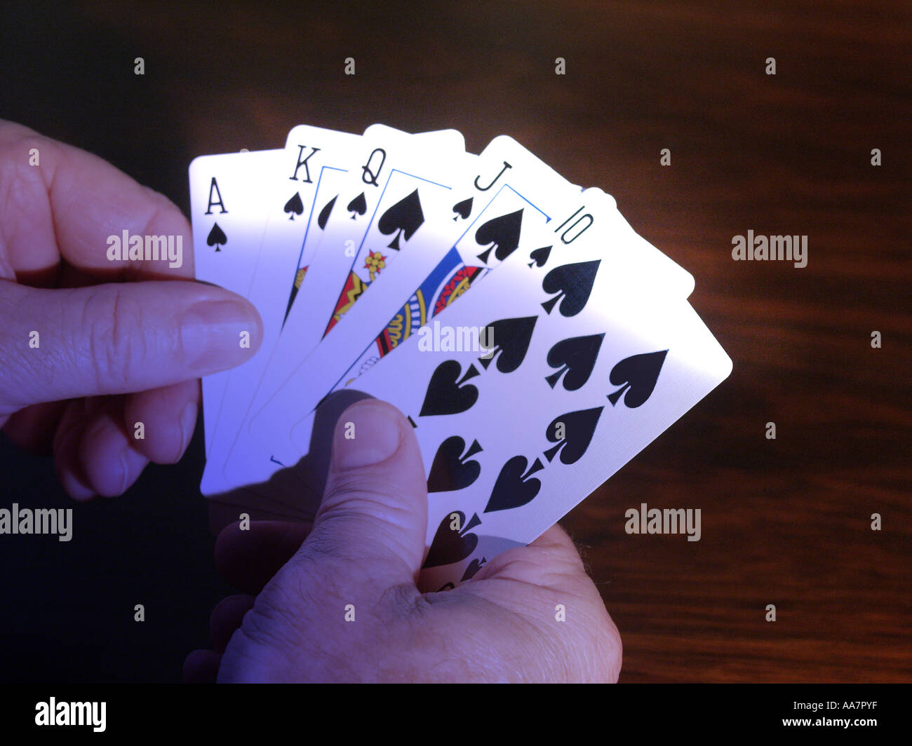 Hand holding royal flush Stock Photo - Alamy