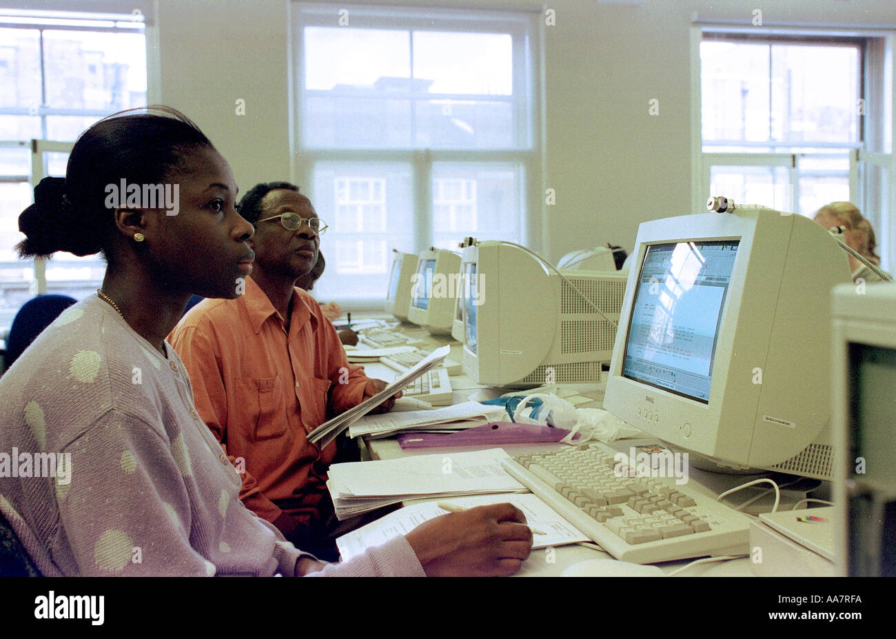 Mature male & female students in computer class at adult education ...