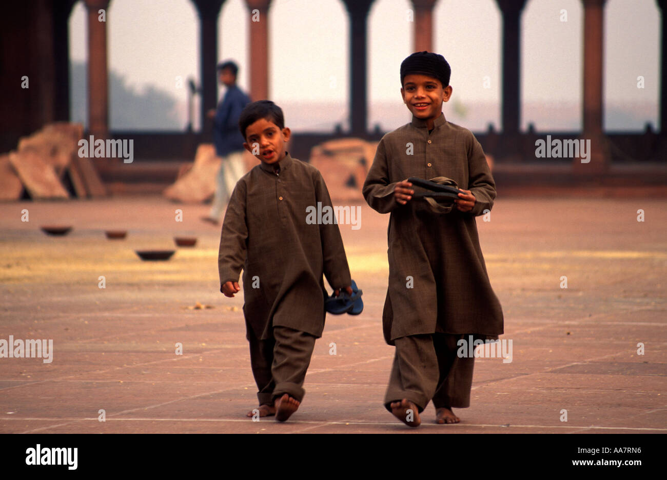 Two young Muslim boys crossing courtyard at Jama Masjid Mosque, Old ...