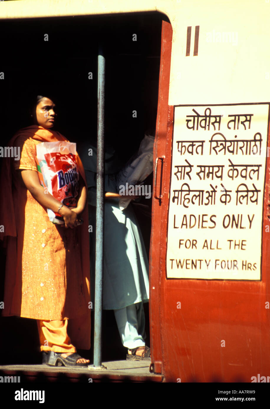 Indian lady standing in doorway of Ladies' Only carriage, Mumbai, South ...