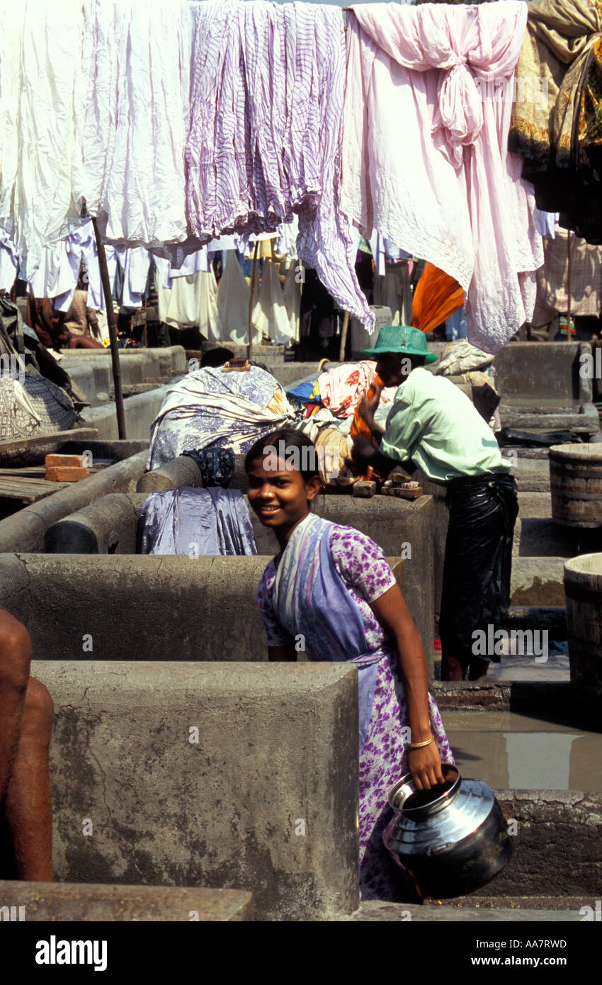 Young Indian female dhobi carrying water canister at Municipal Dhobi ...