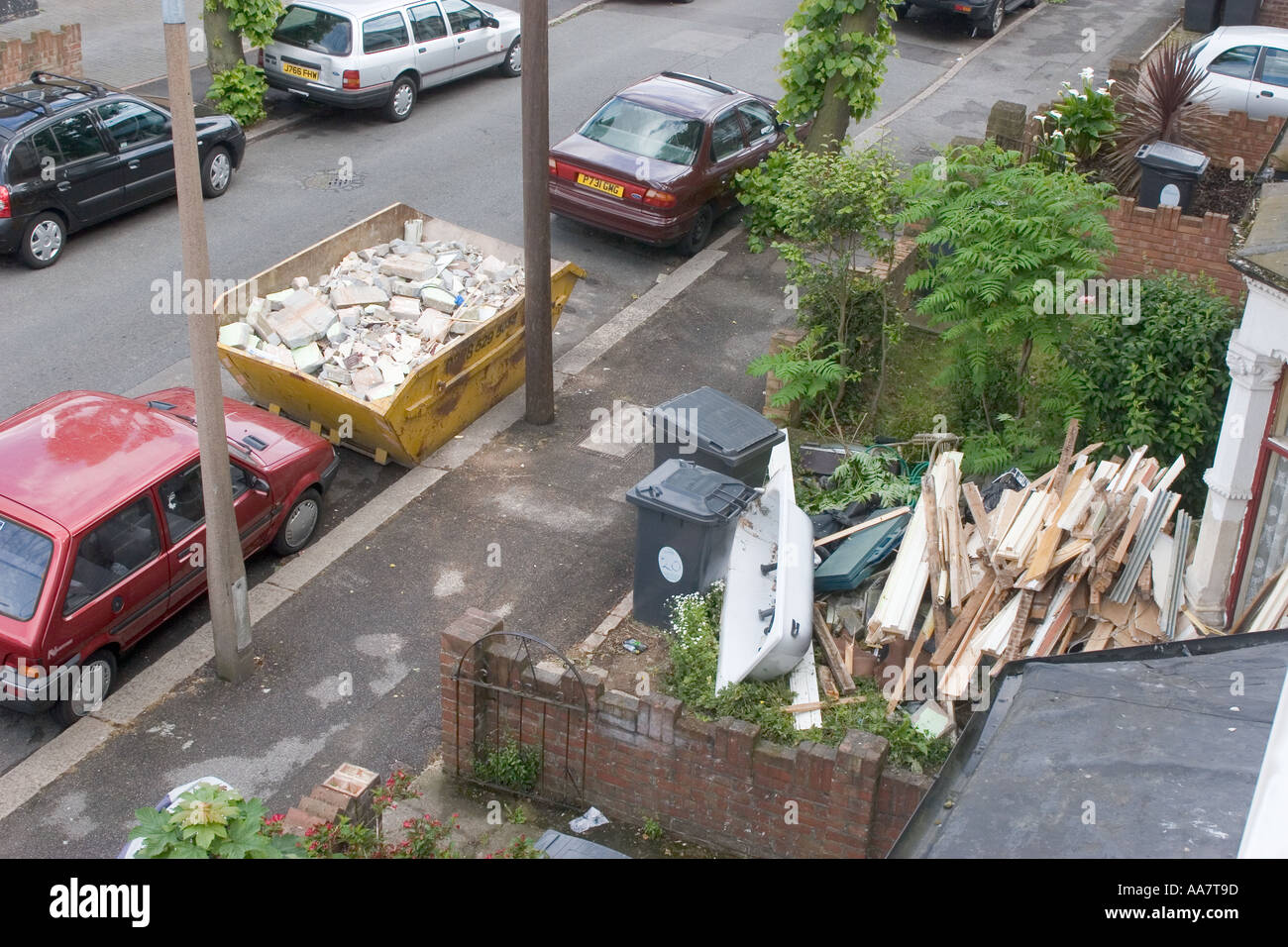 Skip in road and Front garden full of rubbish outside private ...