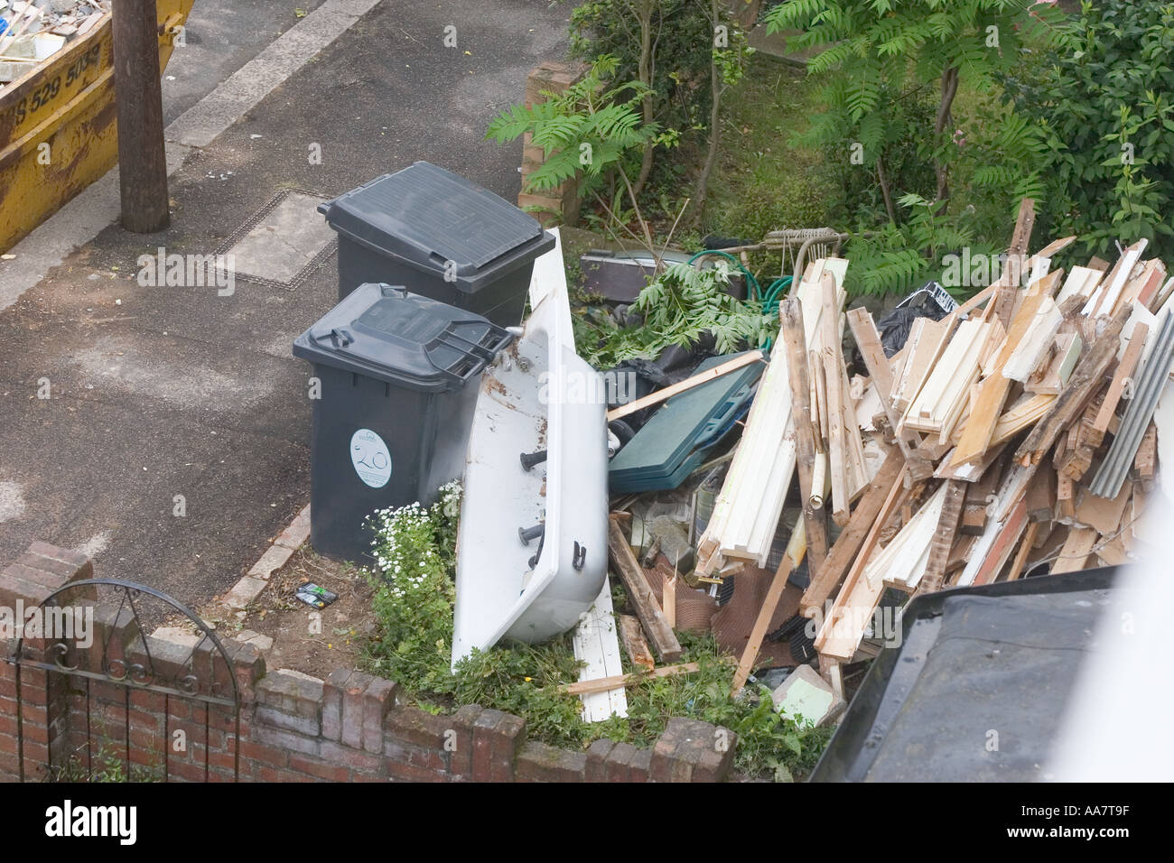 Front garden full of rubbish outside private residential housing ...