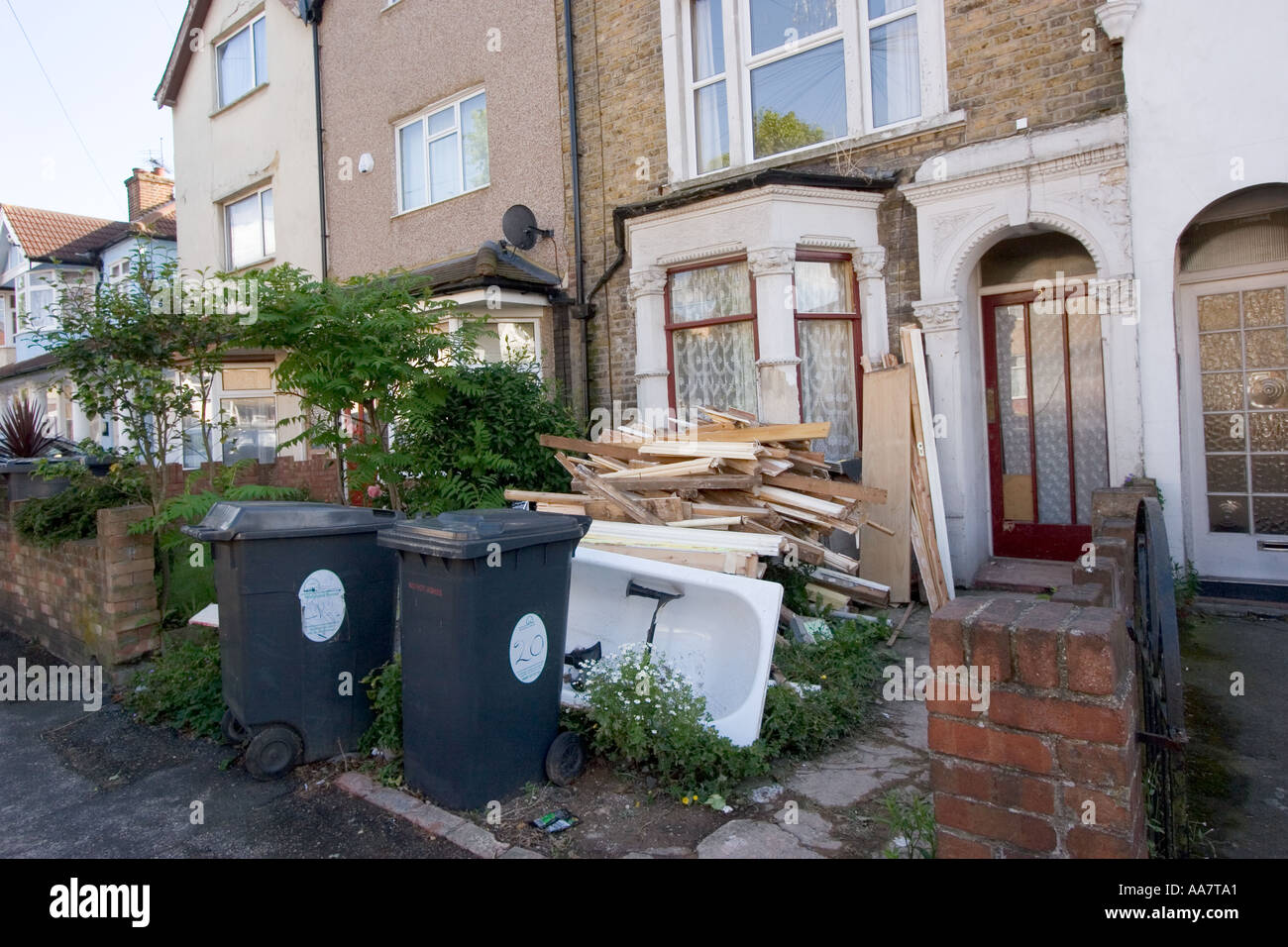 Front garden full of rubbish outside private residential housing ...
