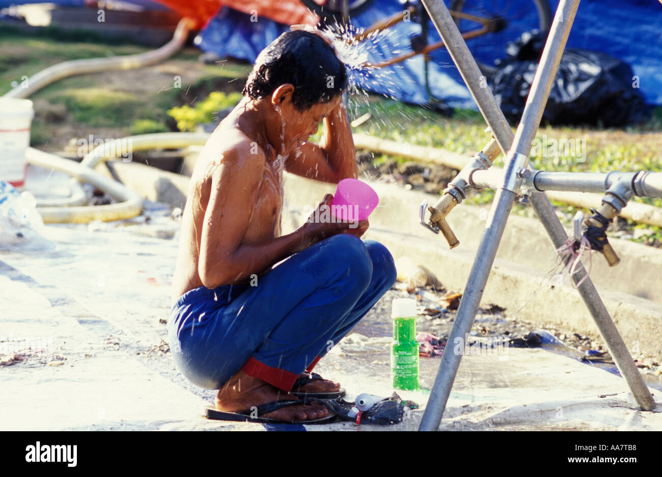 Tsunami survivor boy washing at standpipe Banda Aceh Stock Photo - Alamy
