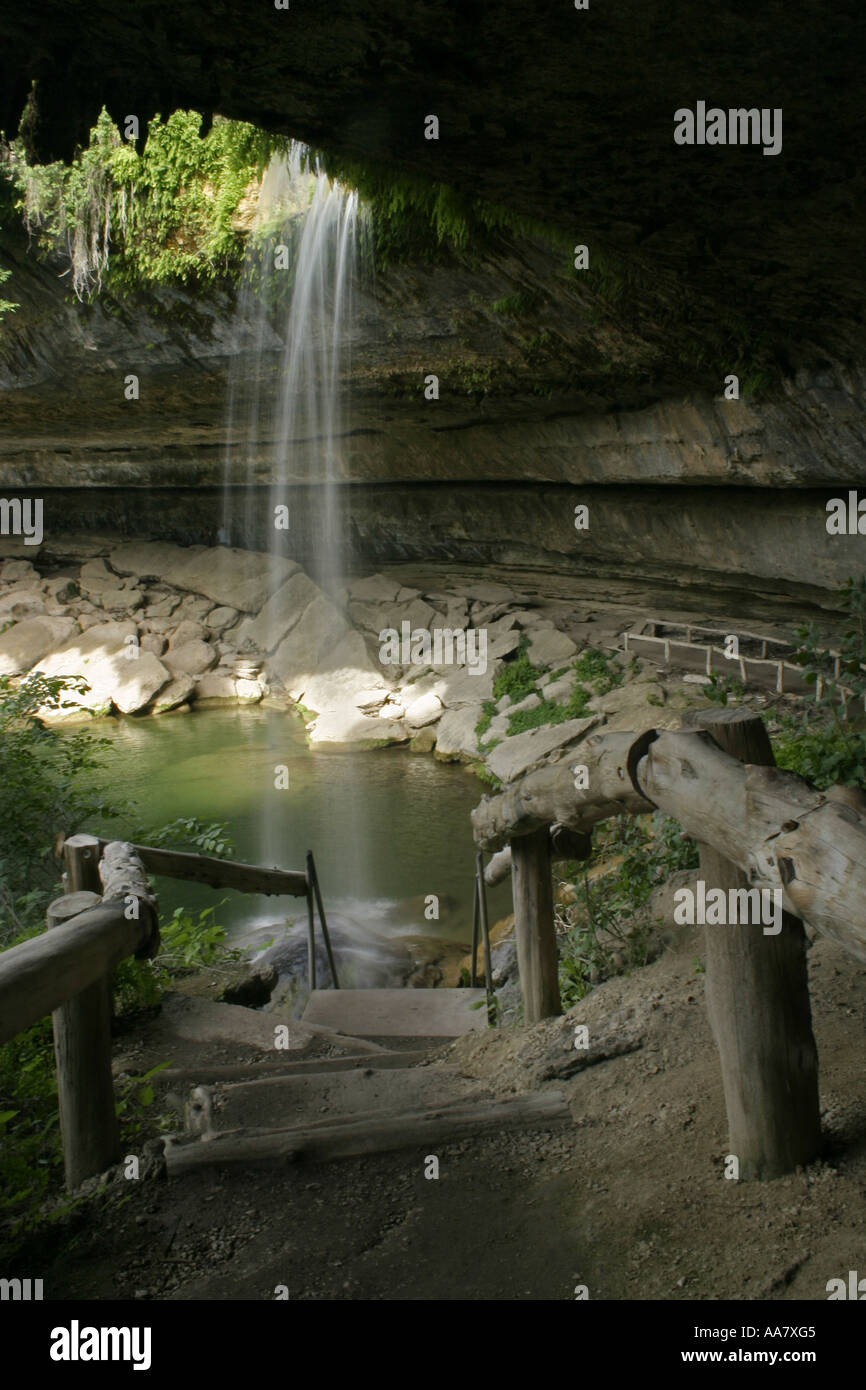 A staircase desends towards the waterfall at Hamilton Pool in Texas ...