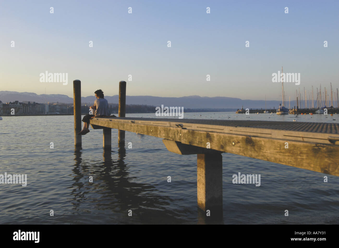 Couple in love sitting on the dock of the lake port Geneva Switzerland ...