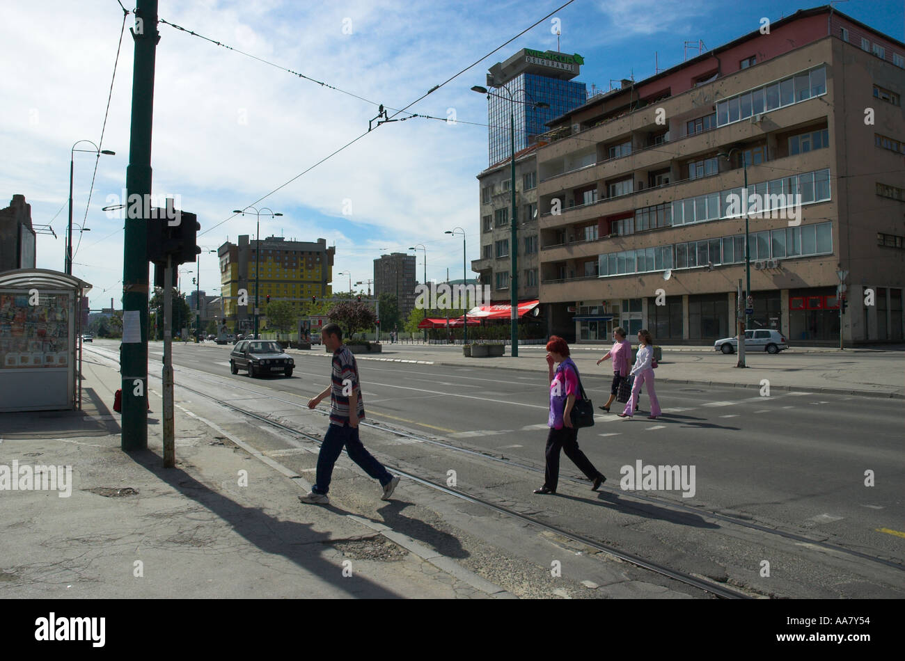 Bosnia Sarajevo sniper alley backlit view with people crossing road ...