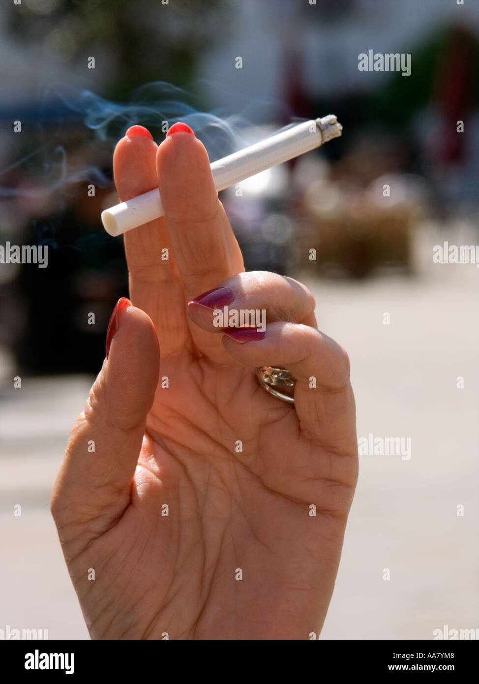 Womans hand holding lighted cigarette hi-res stock photography and ...