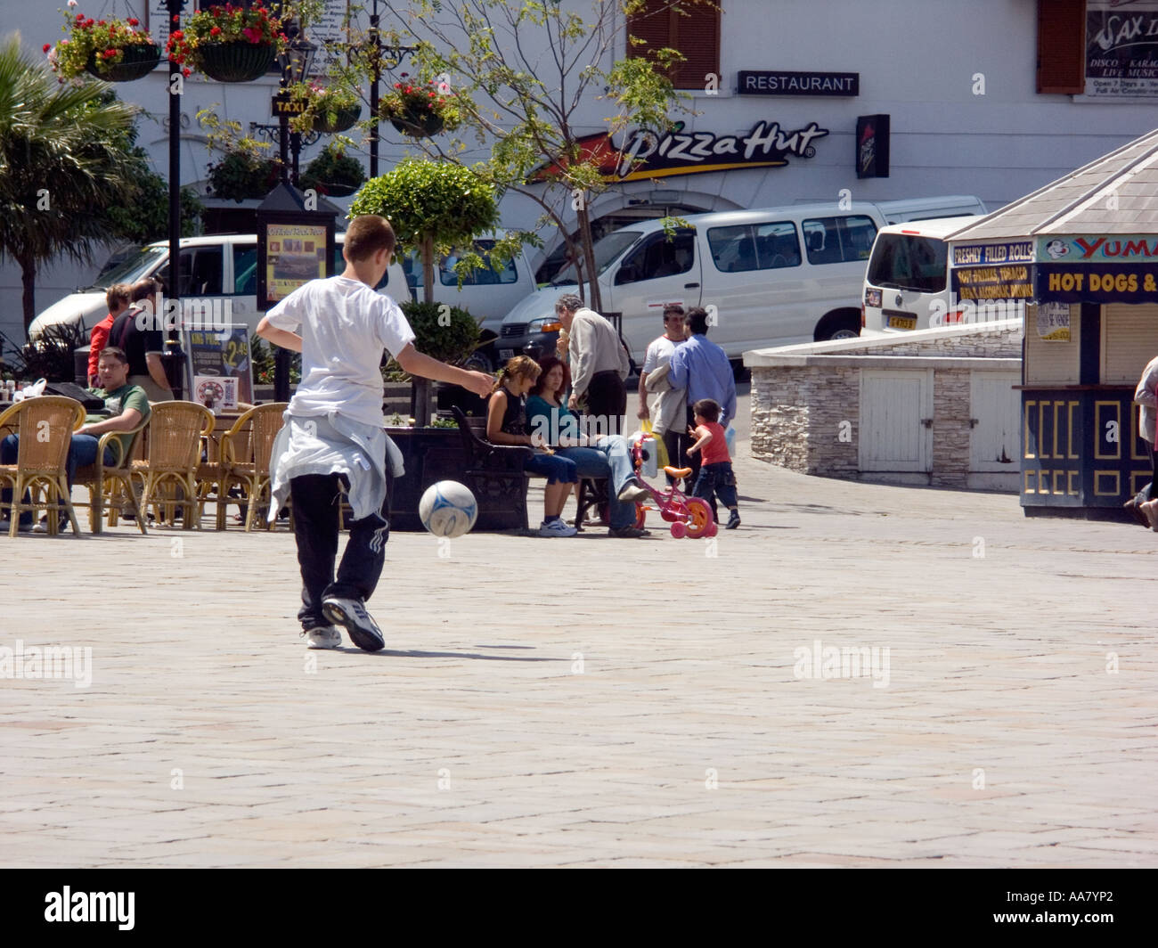 Boy playing football, Casemates Square, Gibraltar Stock Photo - Alamy