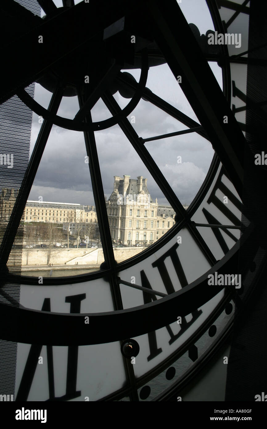 The Louvre as viewed from the big clock in the D'Orsay in Paris, France ...