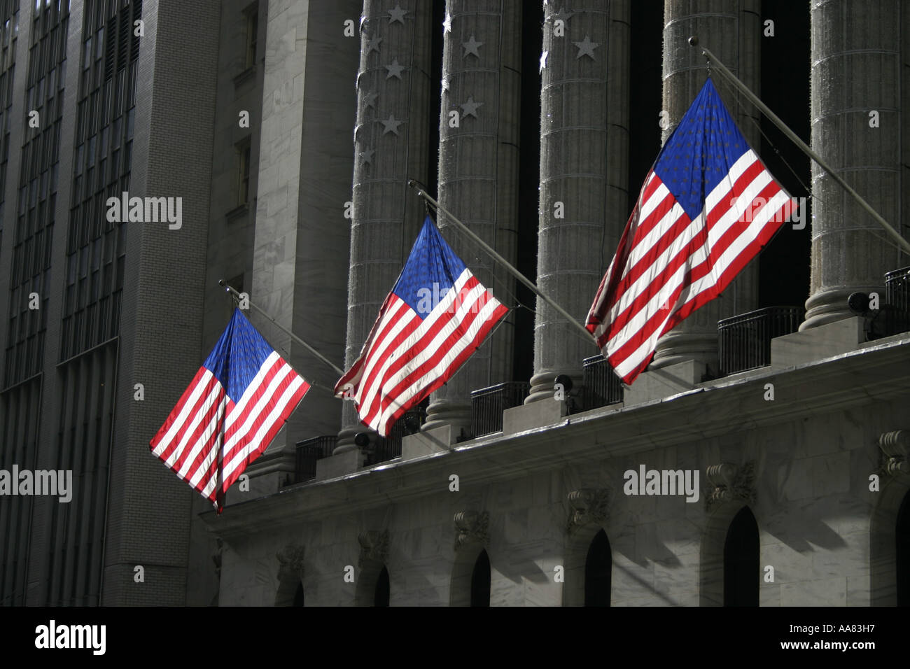 New York Stock Exchange: American flags illuminated by the sun on Wall ...