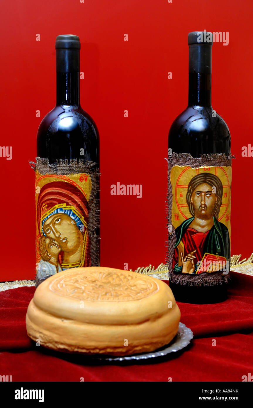 Two sacramental wine bottles with religious icons on labels and bread ...