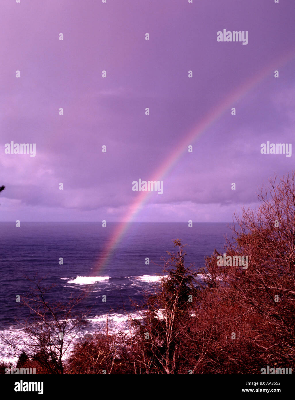 Rainbow over the ocean ends in a breaking wave Stock Photo - Alamy
