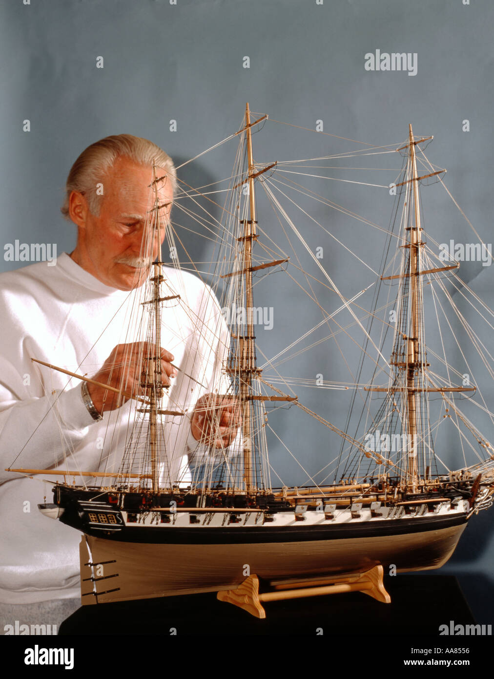 Senior citizen building a ship model Stock Photo - Alamy