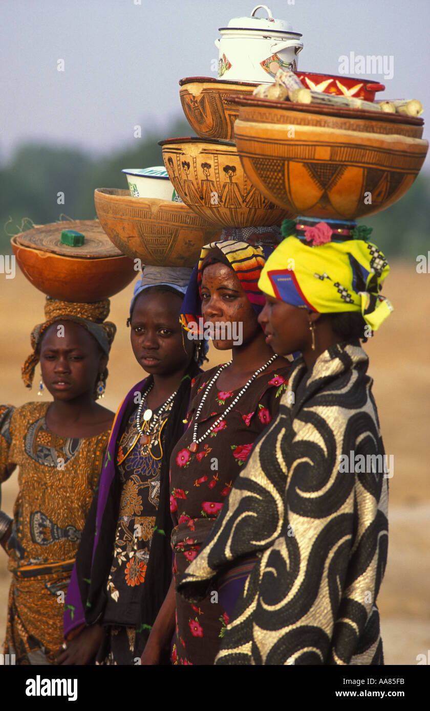 Four Fulani women with calabashes on their heads Stock Photo - Alamy