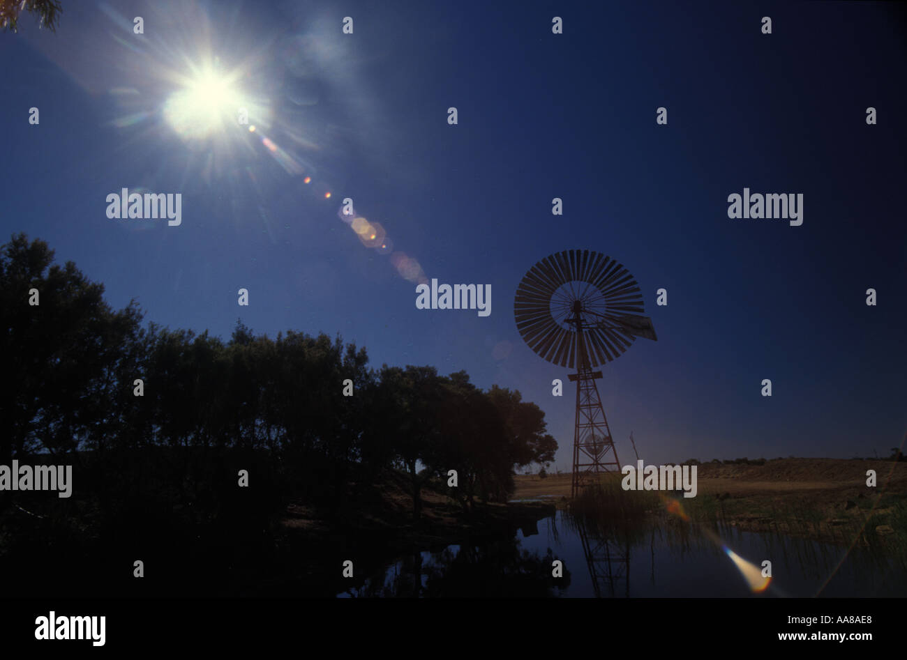 Windmill ans sun lens flare Stock Photo - Alamy