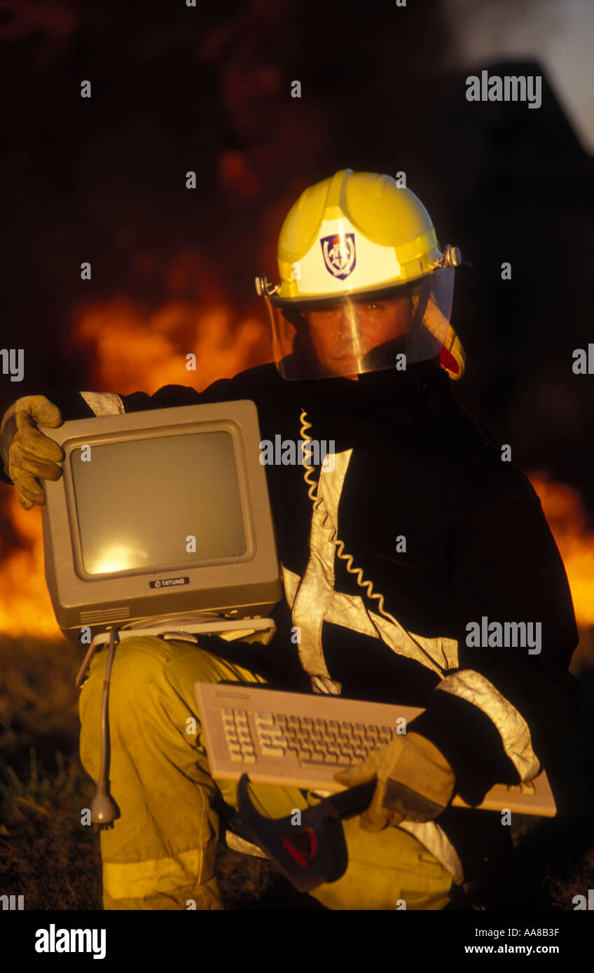 Fireman rescuing computer from flames Stock Photo - Alamy