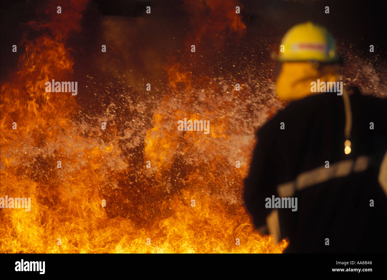 Fireman and flames Stock Photo - Alamy