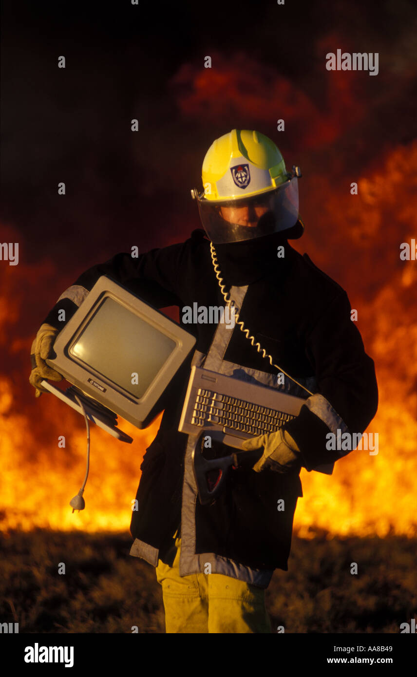 Fireman rescuing computer from flames Stock Photo - Alamy