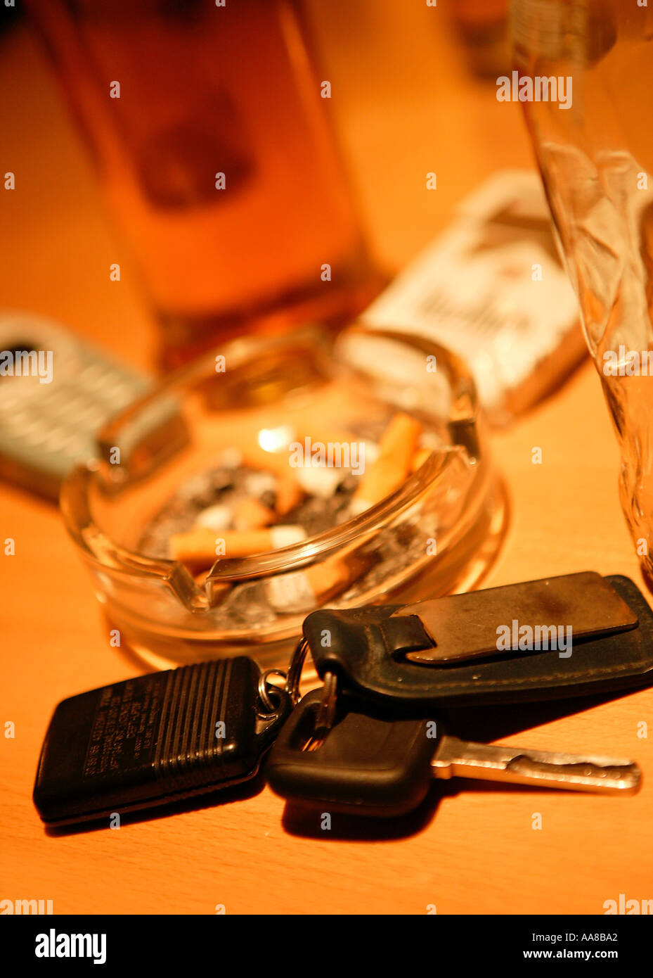 CAR KEYS ON PUB TABLE WITH ASH TRAY AND ALCOHOLIC DRINK IN BACKGROUND ...