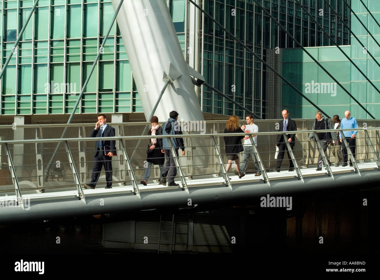 The modern bridge with people crossing between Skyscrapers on the Isle ...