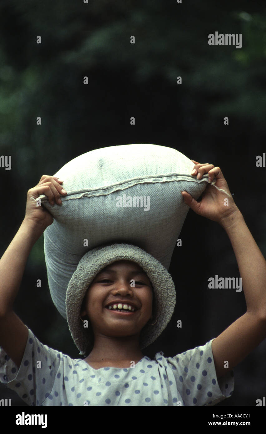 A local girl carries a sack of Rice, Angkor Wat, Cambodia Stock Photo ...