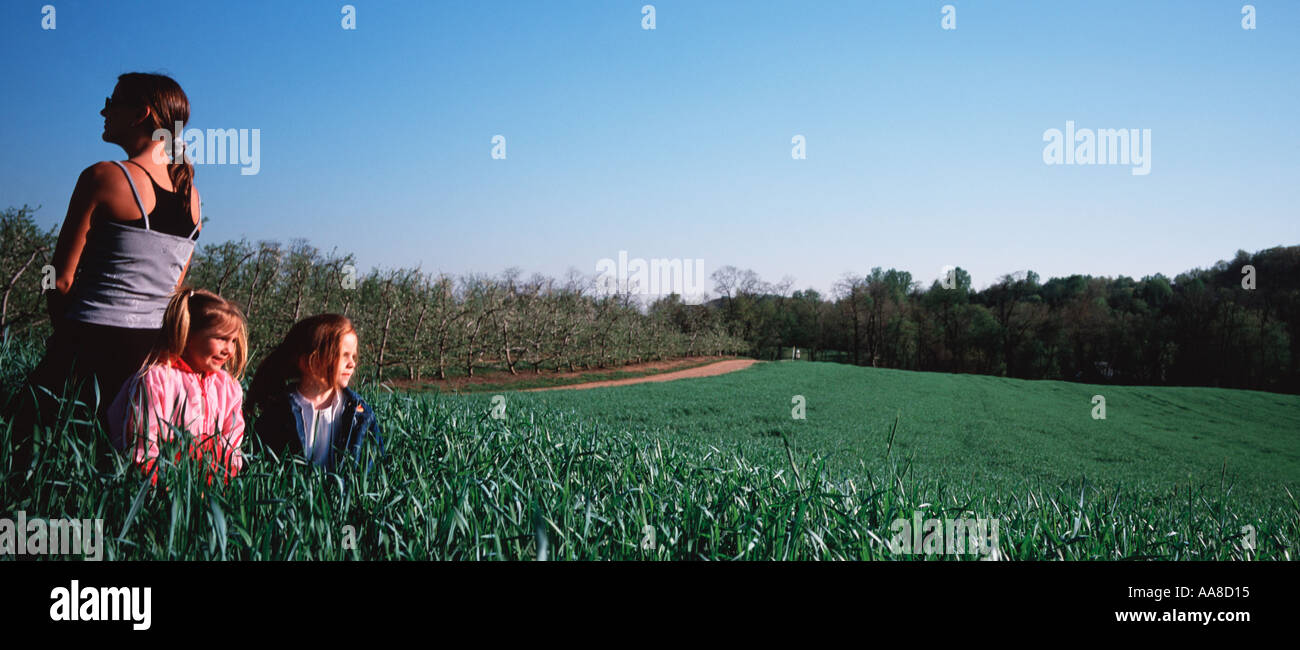Family in field Stock Photo - Alamy