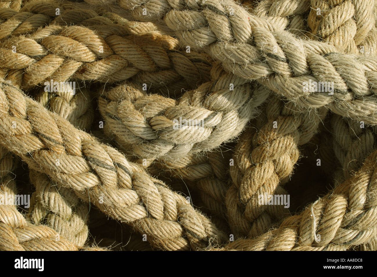 Thick coiled old rope Stock Photo - Alamy