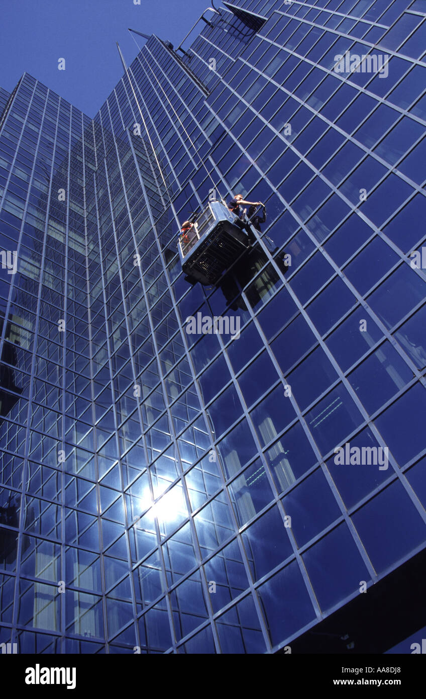 Window cleaners scrub the facade of a London city skyscraper on the ...