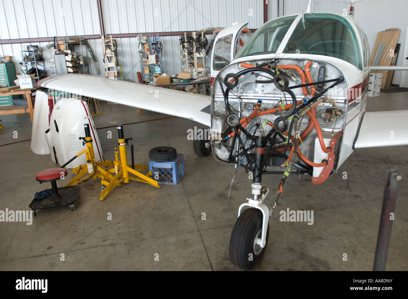 Airplane undergoing mechanical work in the hangar Stock Photo - Alamy