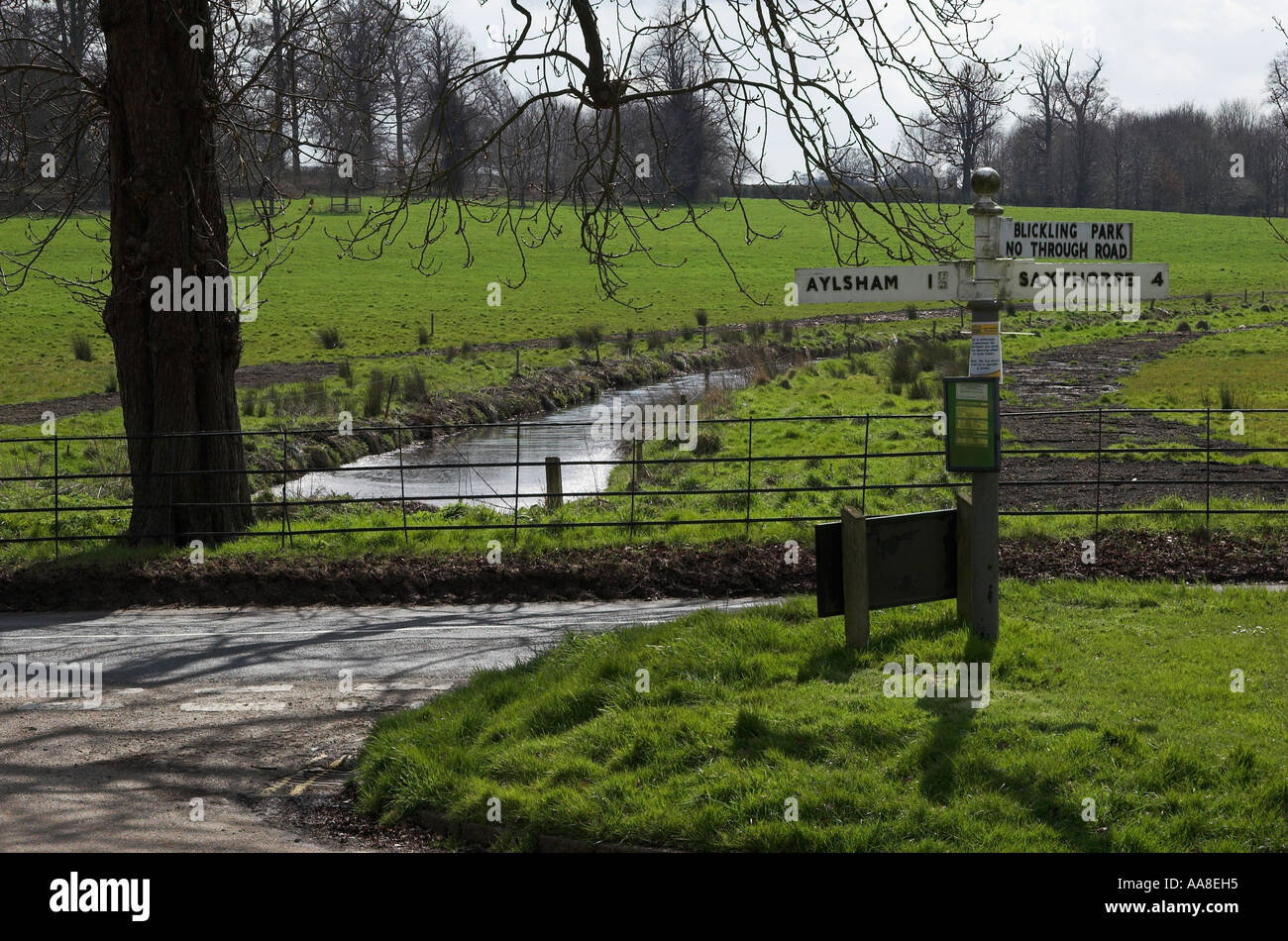 Meadow, stream and old-fashioned signpost at Blickling, Norfolk ...