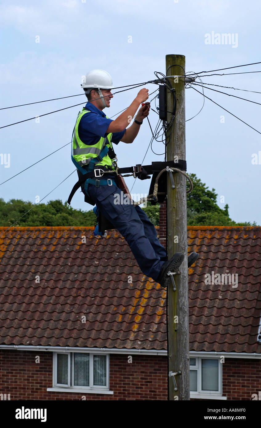 A Telephone Engineer at work wearing full and correct safety equipment ...