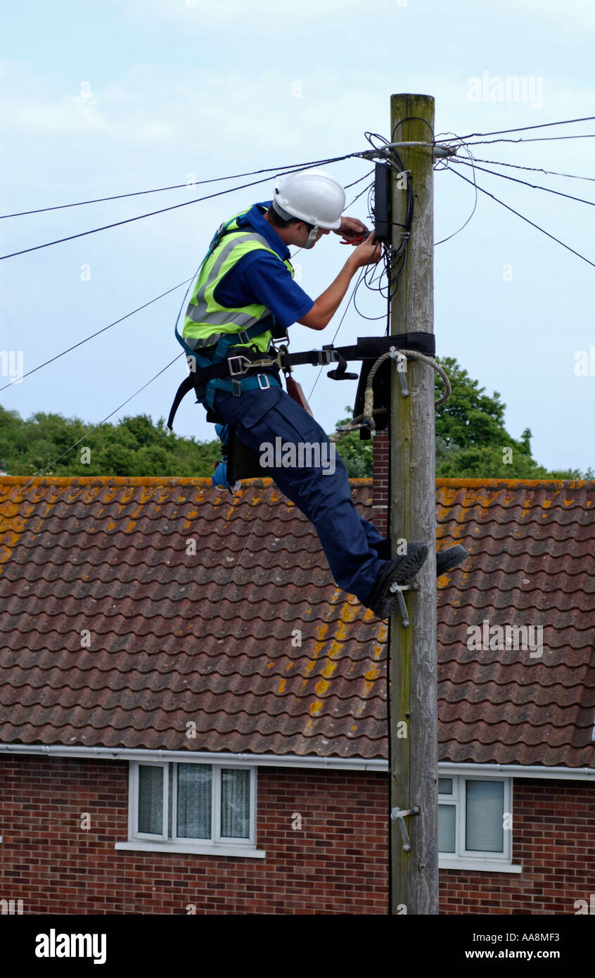 A Telephone Engineer at work wearing full and correct safety equipment ...