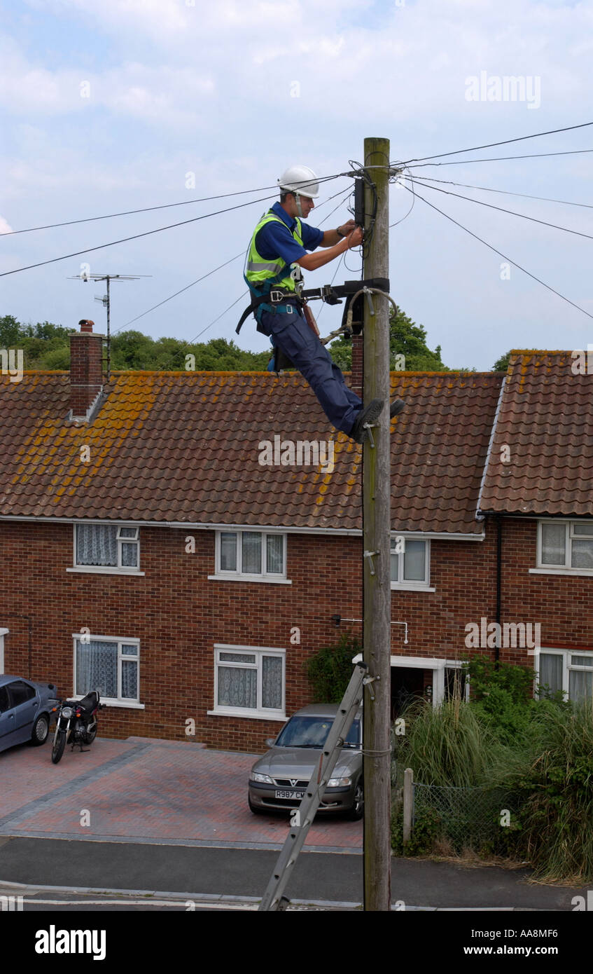 A Telephone Engineer at work wearing full and correct safety equipment ...